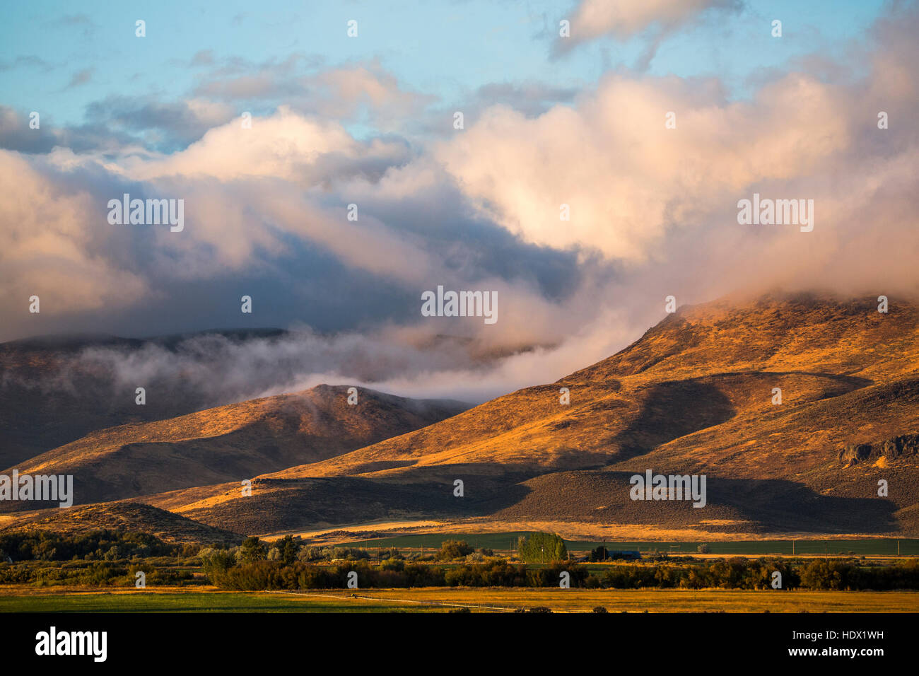 Clouds over mountain range Stock Photo - Alamy