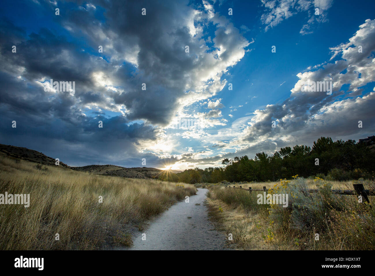 Sunset over distant path Stock Photo - Alamy