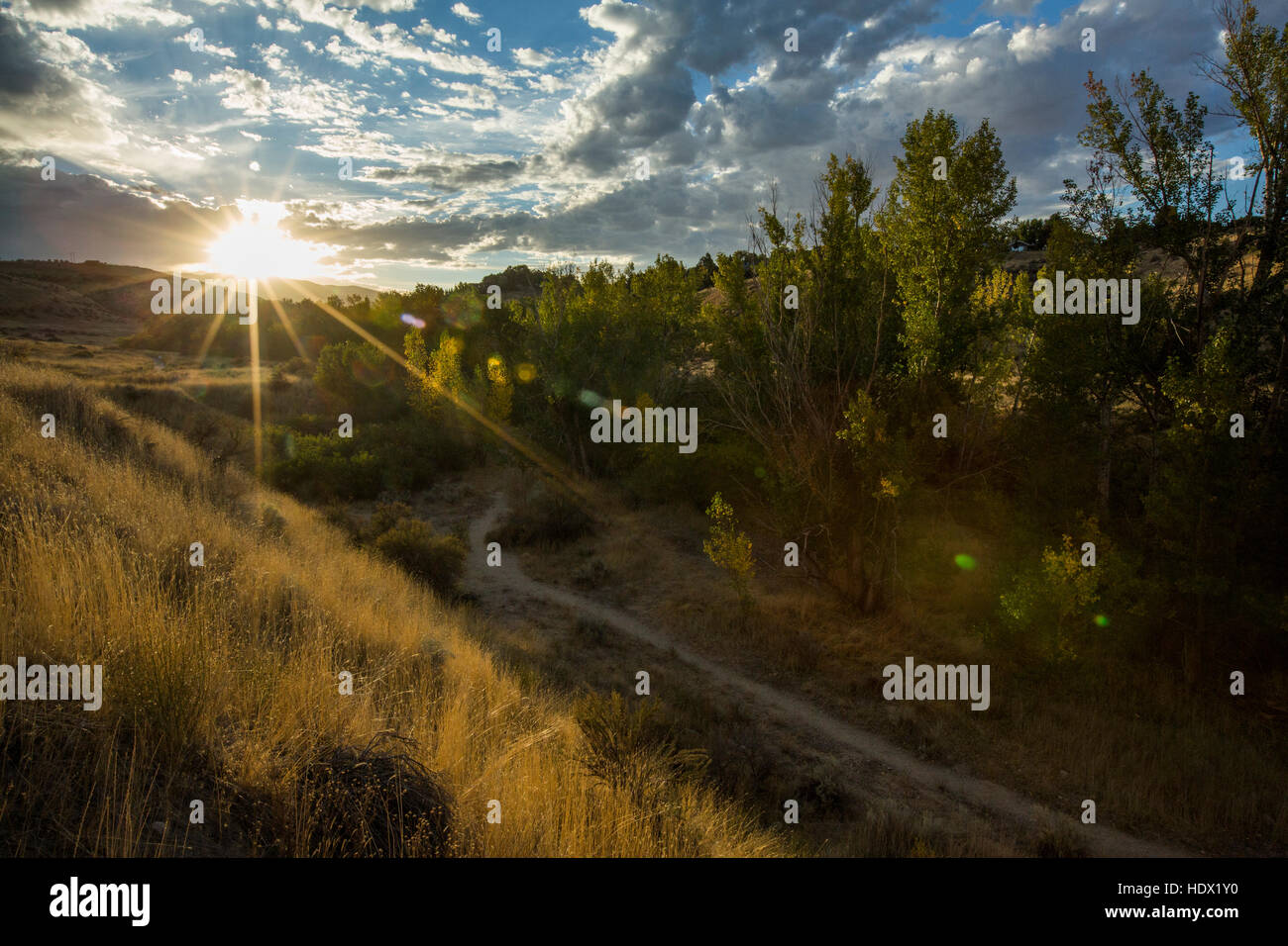 Sunset over distant mountain path Stock Photo - Alamy