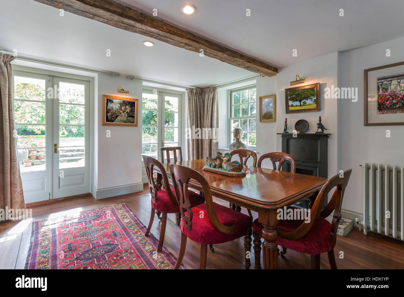 Dining table in sunny room Stock Photo - Alamy