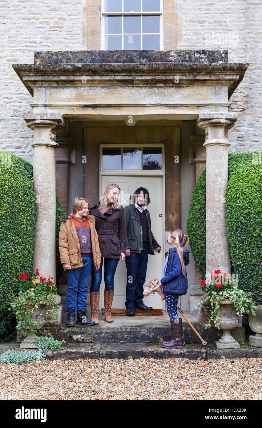 Family standing in front of house hi-res stock photography and images ...