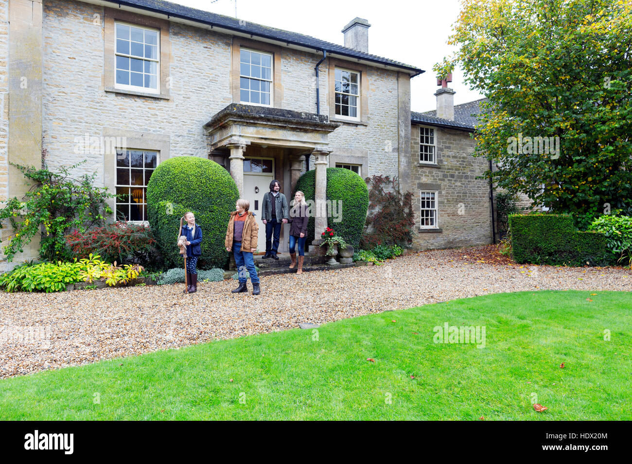 Family standing in front of house hi-res stock photography and images ...