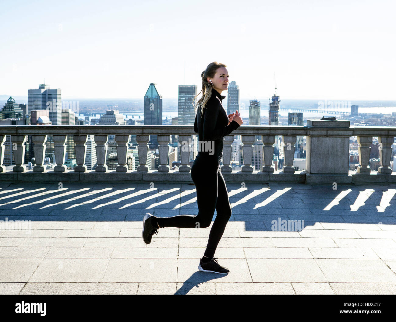 Woman running looking back hi-res stock photography and images - Alamy