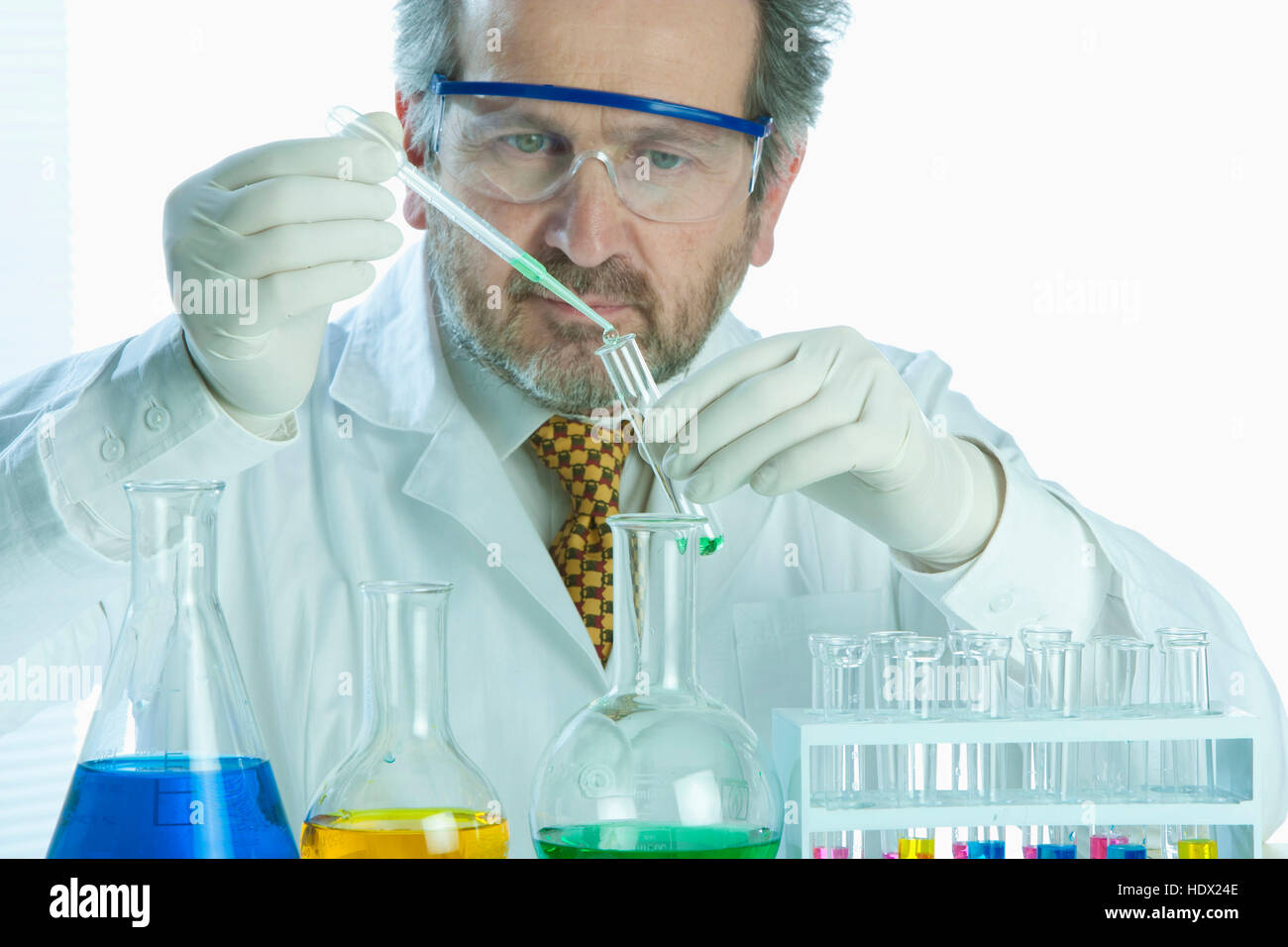 Caucasian scientist mixing liquid in laboratory Stock Photo - Alamy