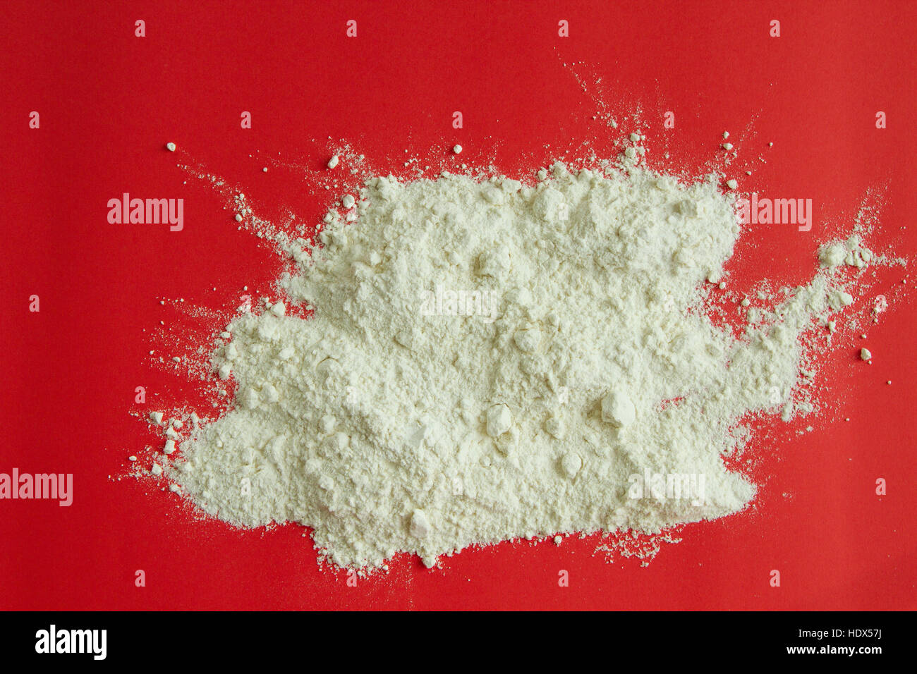 Heap of flour on the red background Stock Photo - Alamy