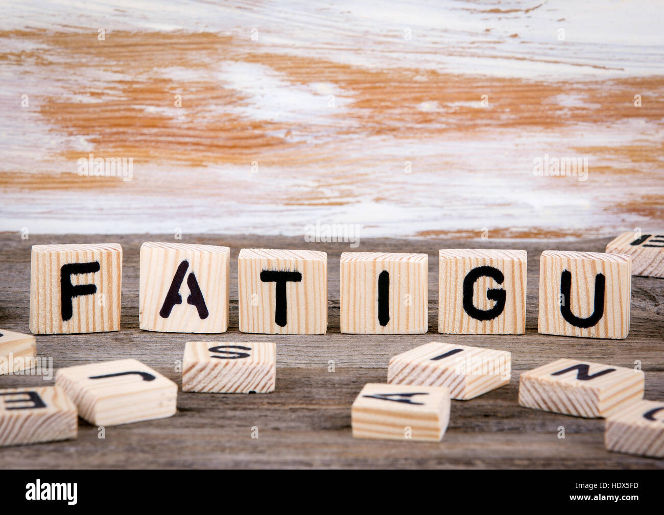 Fatigu from wooden letters on wooden background Stock Photo - Alamy