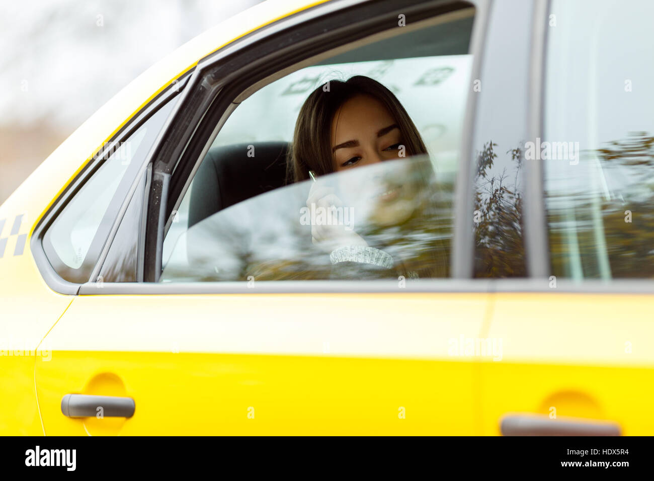 Beautiful girl sitting in yellow taxi for half-open window Stock Photo ...