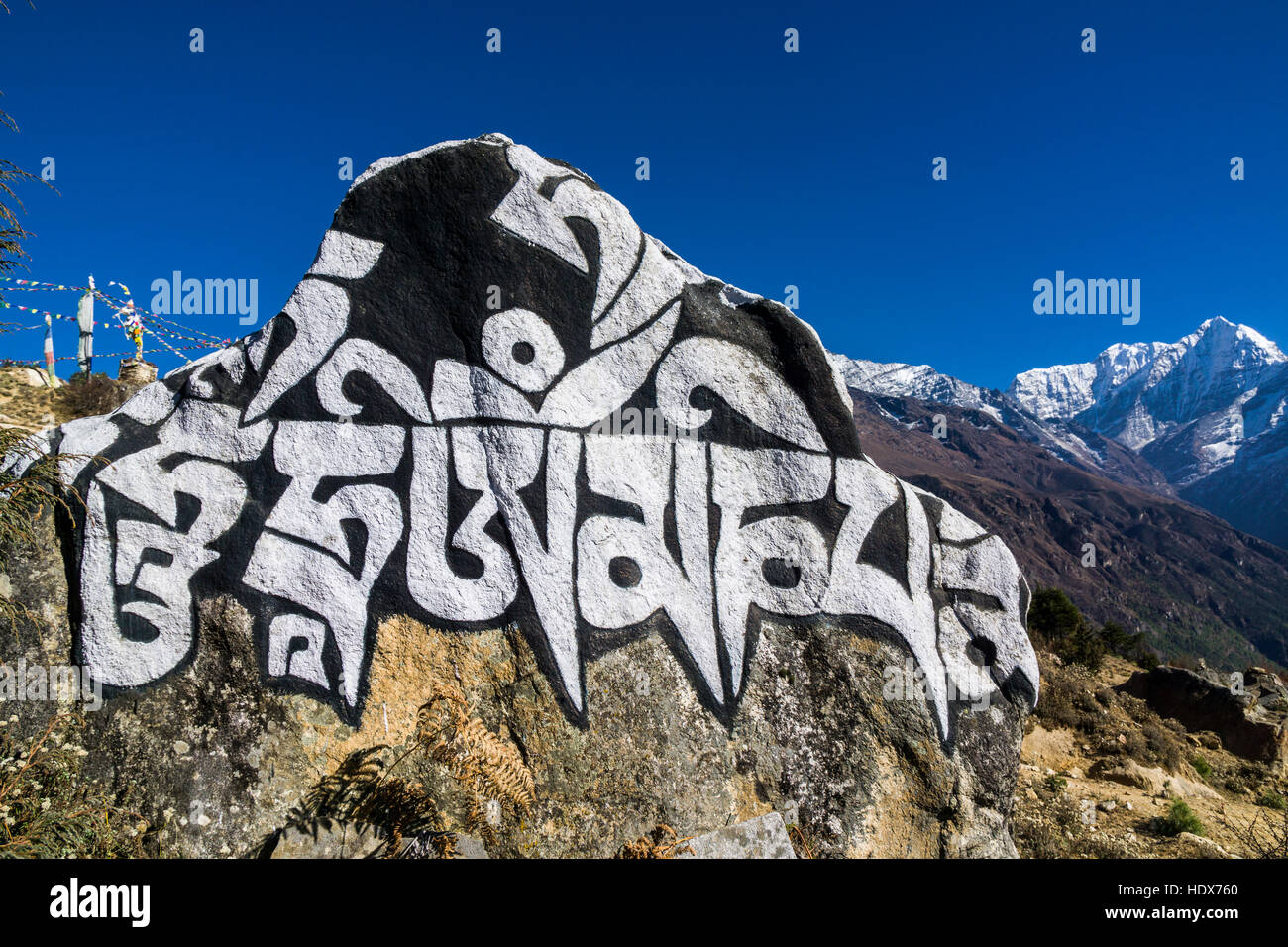 Big Mani stone with the tibetean mantra Om mani padme hum with the ...