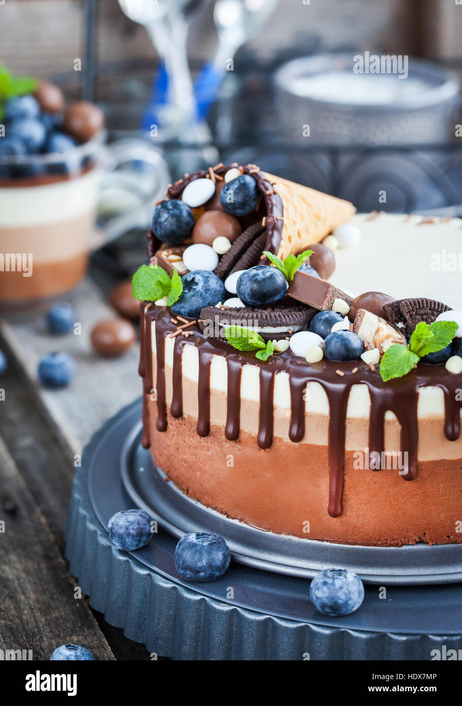 Delicious three chocolate mousse cake decorated with waffle cone, fresh ...