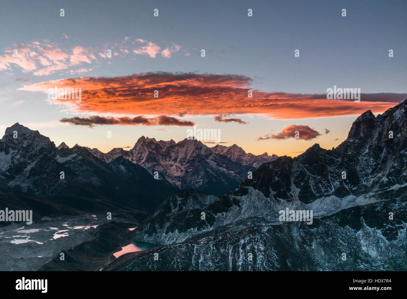 Aerial view from Gokyo Ri (5360m) with a big red cloud at sunrise, snow ...