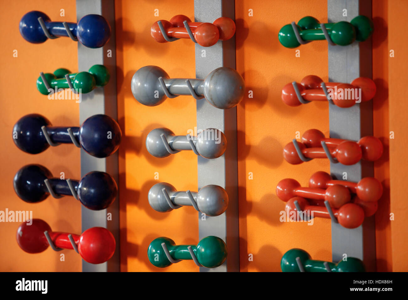 Several dumbbells weights in gym Stock Photo - Alamy