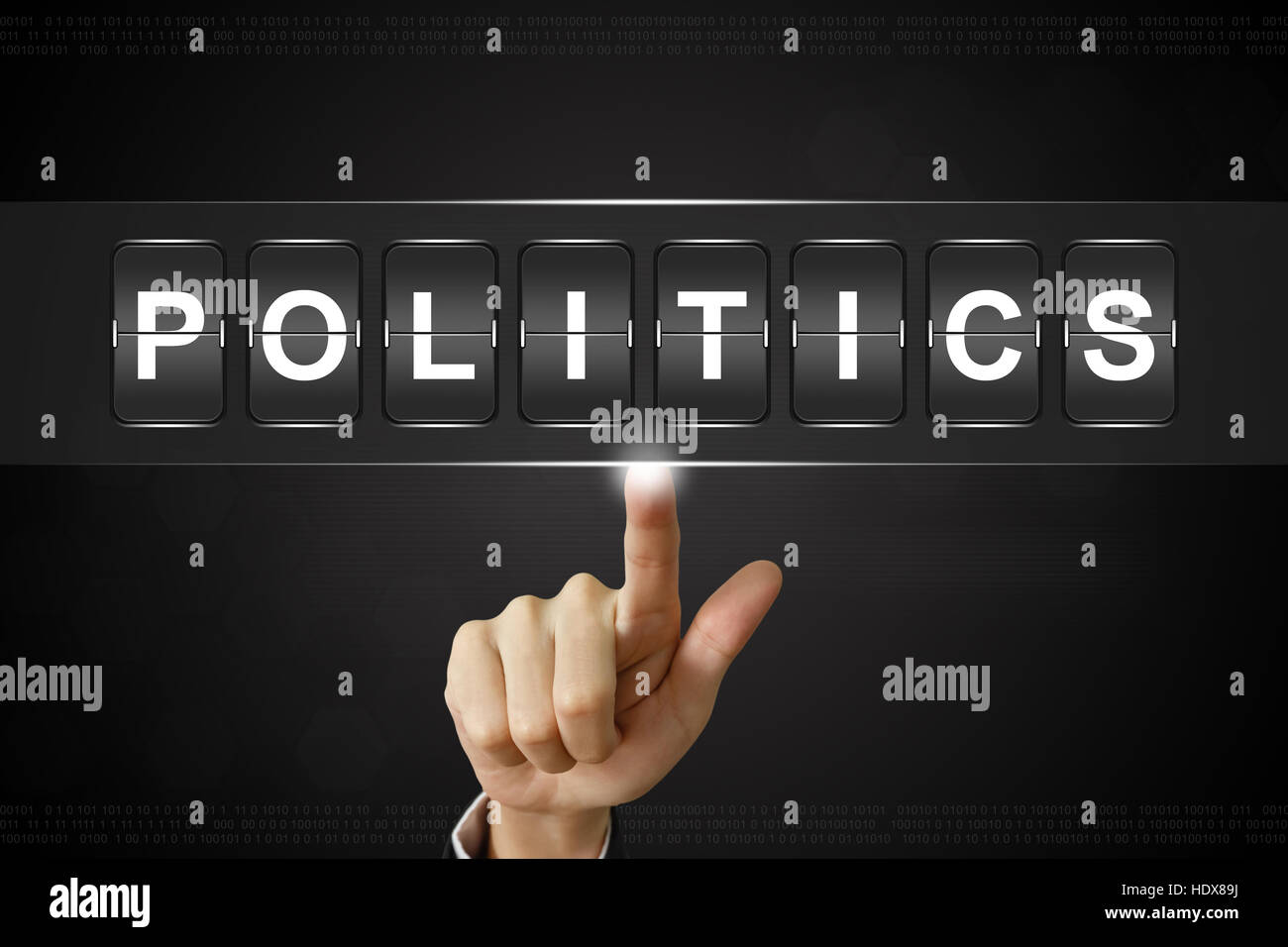 business hand pushing politics on Flipboard Display Stock Photo - Alamy
