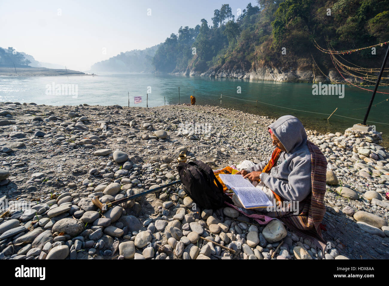 A male pilgrim is studying the religious books at the holy confluence ...