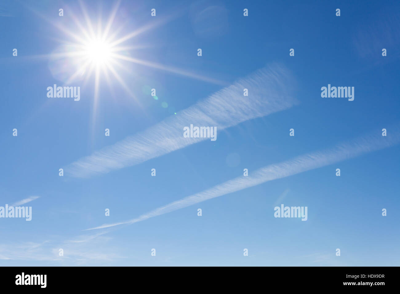 Sun shining blue sky Stock Photo - Alamy