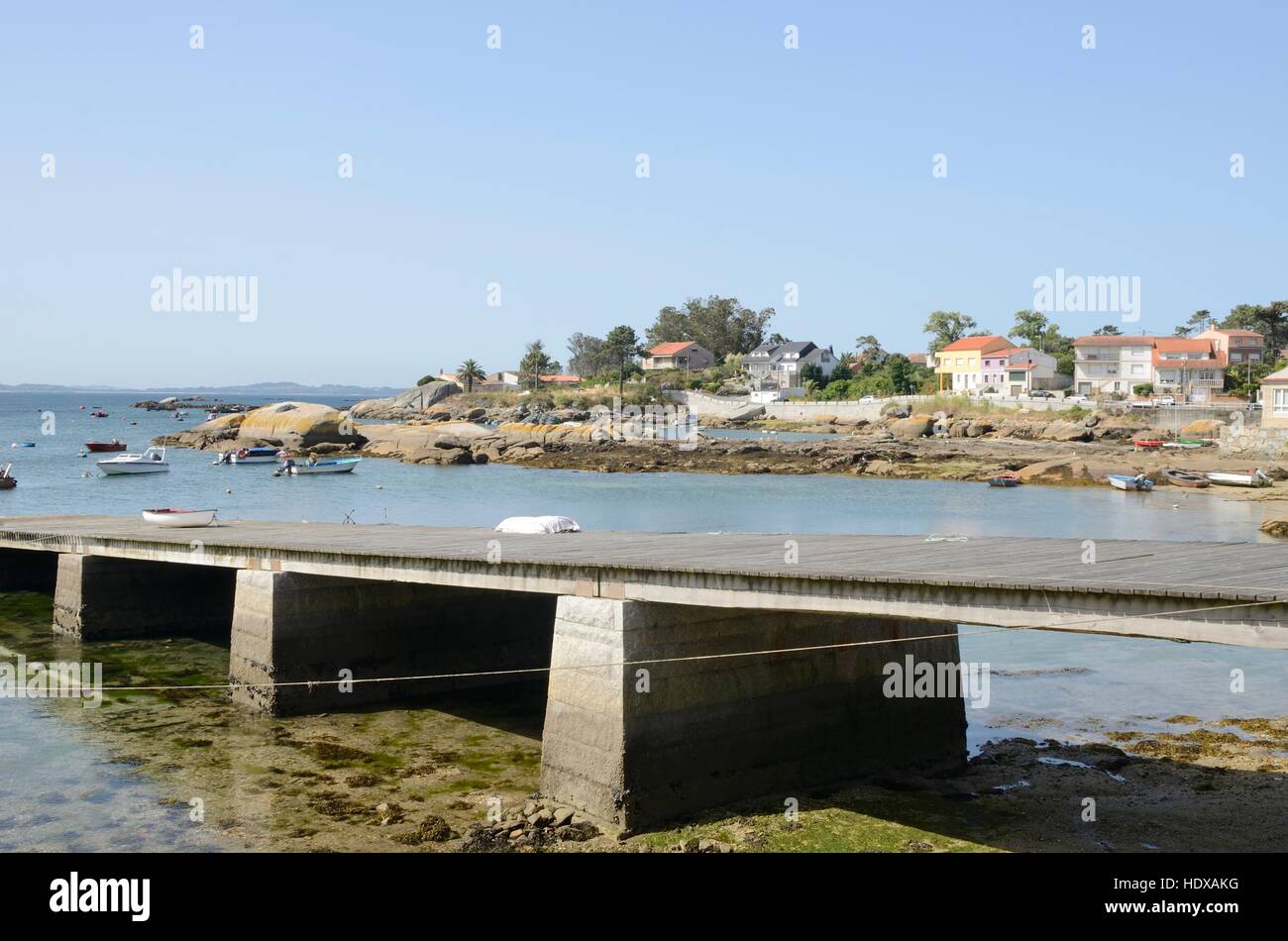 Wooden pier and fishing boats at the beach in Island of Arousa, in the ...