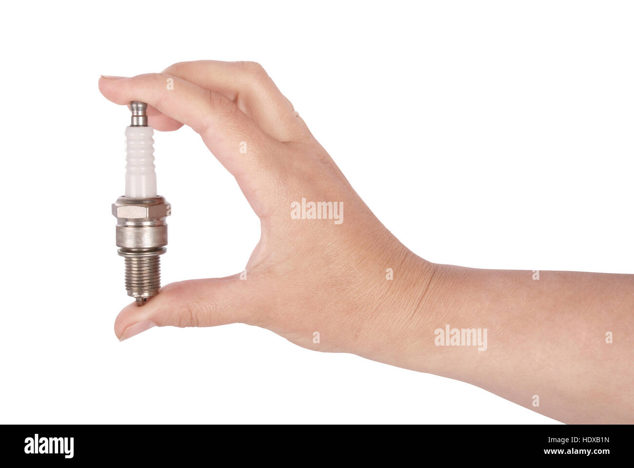 New sparking plug in a hand on a isolated white background. Photo with ...