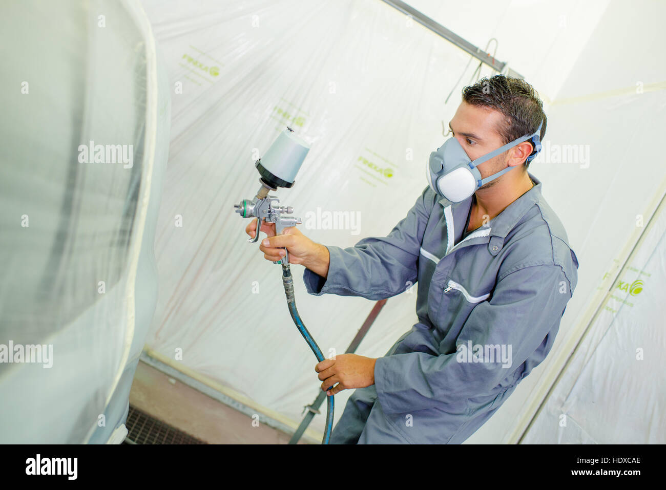 Man spraying paint with air tool Stock Photo - Alamy