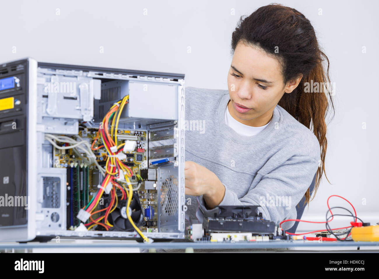 Woman repairing computer Stock Photo - Alamy