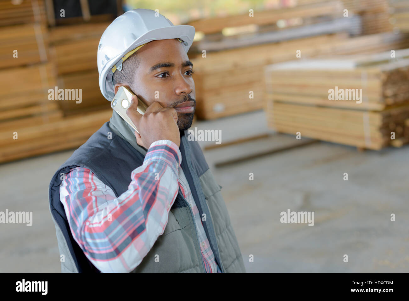 Man in timber store using cellphone Stock Photo - Alamy