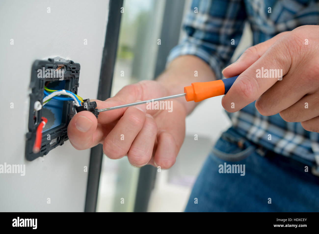 Man connecting wires on dismantled switch Stock Photo - Alamy