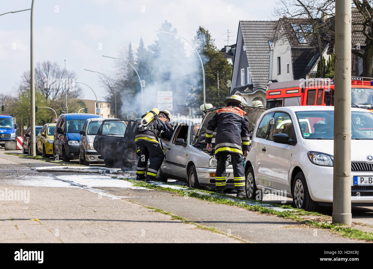 Fire Brigade extinguish burning car Stock Photo - Alamy