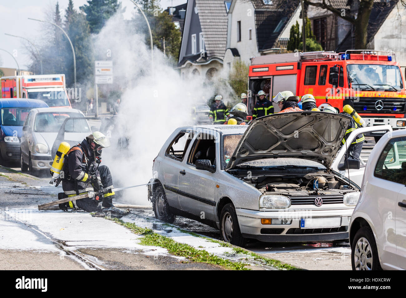 Fire Brigade extinguish burning car Stock Photo - Alamy