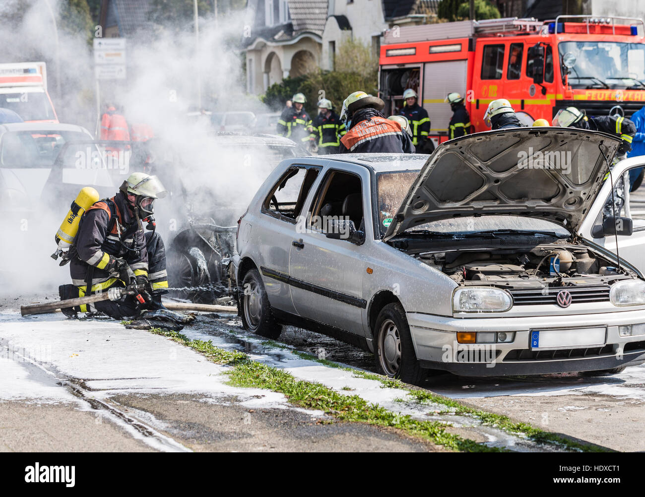 Fire Brigade extinguish burning car Stock Photo - Alamy