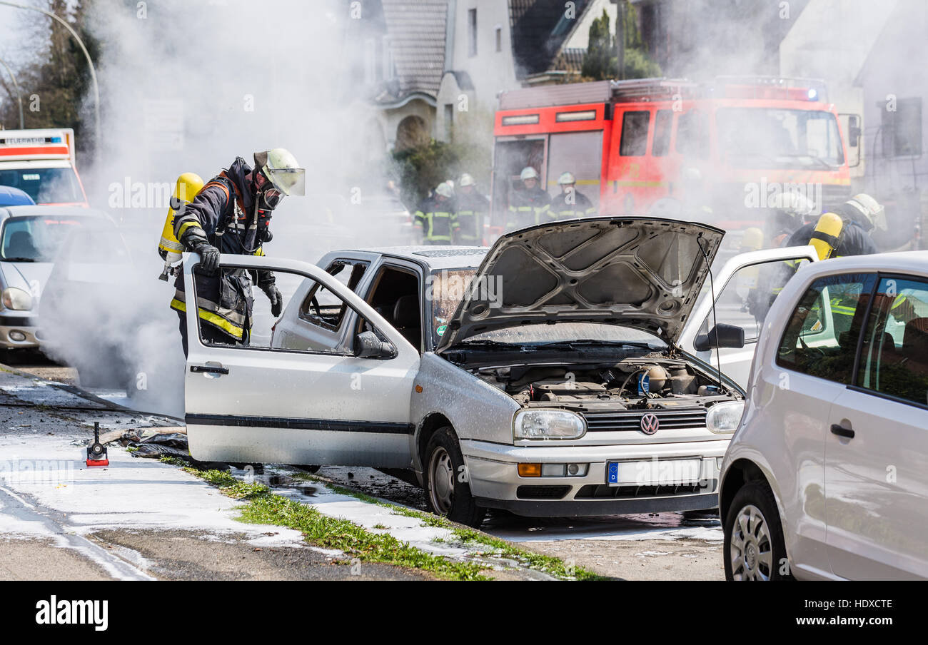 Fire Brigade extinguish burning car Stock Photo - Alamy