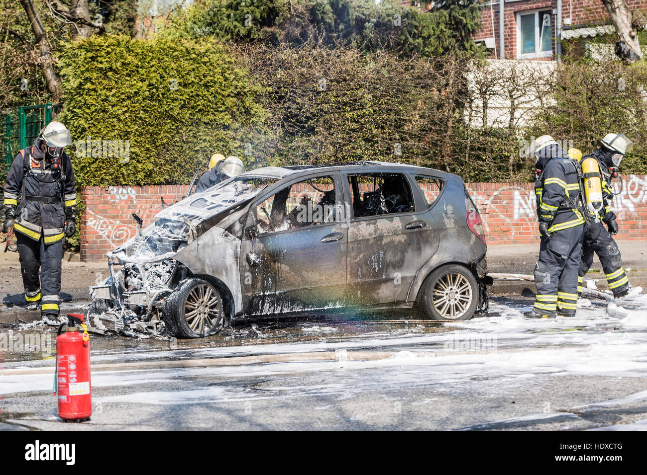 Fire Brigade extinguish burning car Stock Photo - Alamy