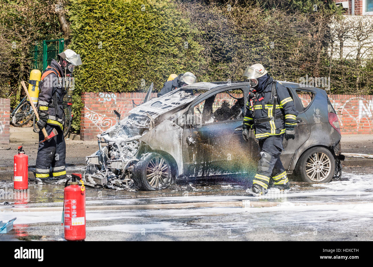 Fire Brigade extinguish burning car Stock Photo - Alamy
