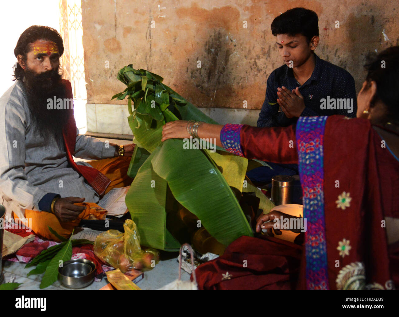 A Hindu priest performing a Puja ceremony inside the Shiva Dol temple ...