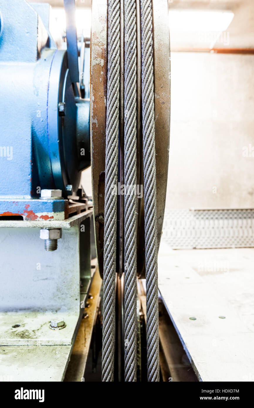 iron cables on a wheel of a motor of the elevator Stock Photo - Alamy