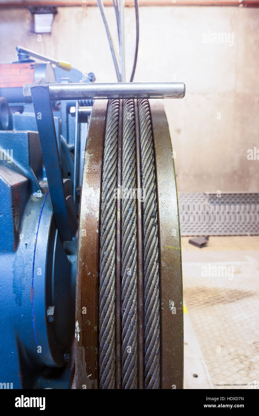 iron cables on a wheel of a motor of the elevator Stock Photo - Alamy