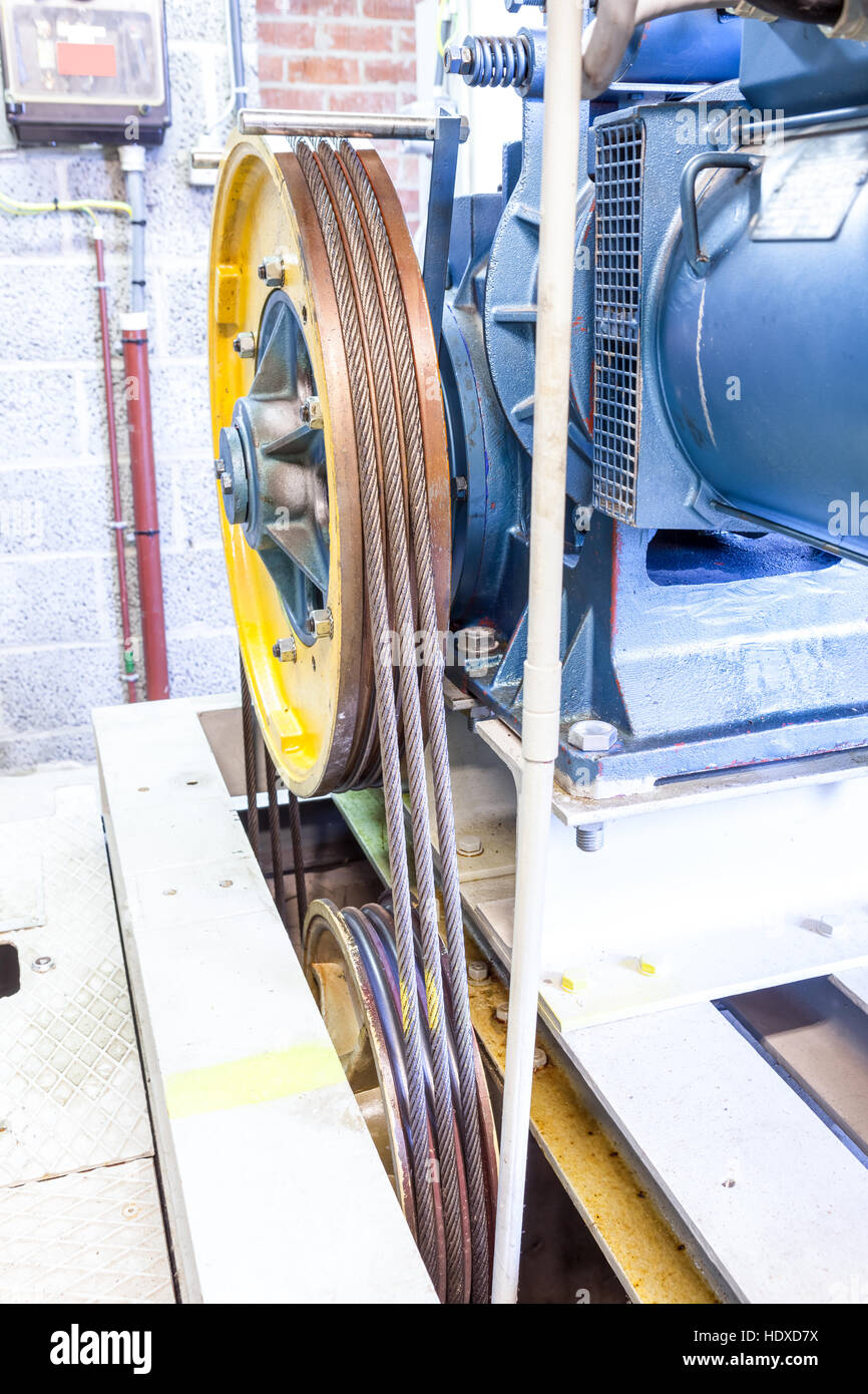 iron cables on a wheel of a motor of the elevator Stock Photo - Alamy