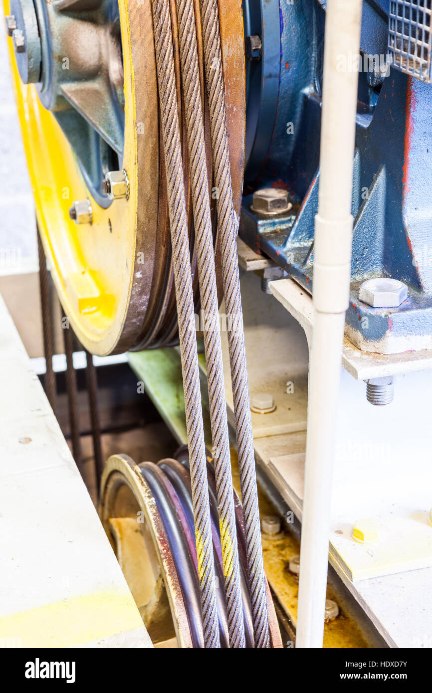 iron cables on a wheel of a motor of the elevator Stock Photo - Alamy