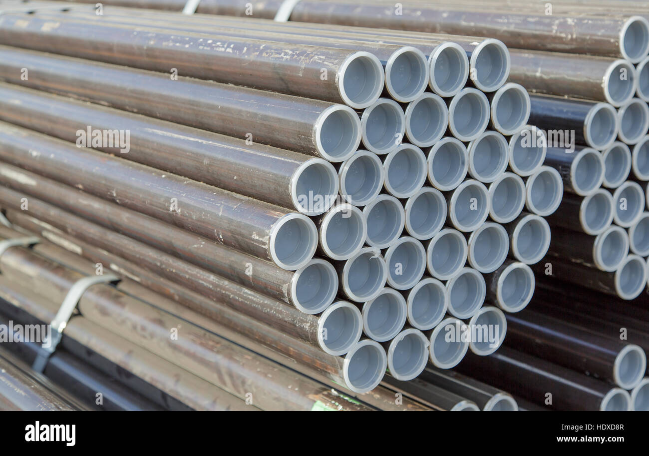 Iron pipes laid and fastened in the stack Stock Photo - Alamy