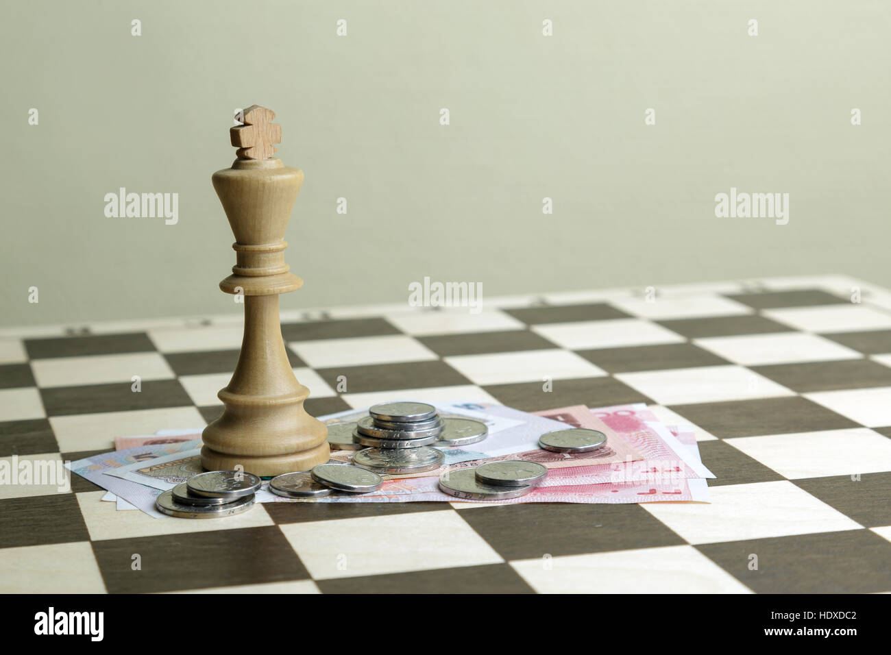 Chess the king with money for a chessboard Stock Photo - Alamy