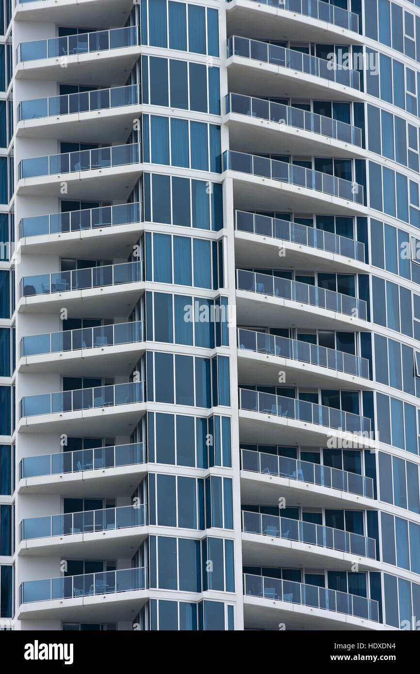 Skyscraper wall with blue glass windows and balcony railings and smooth ...
