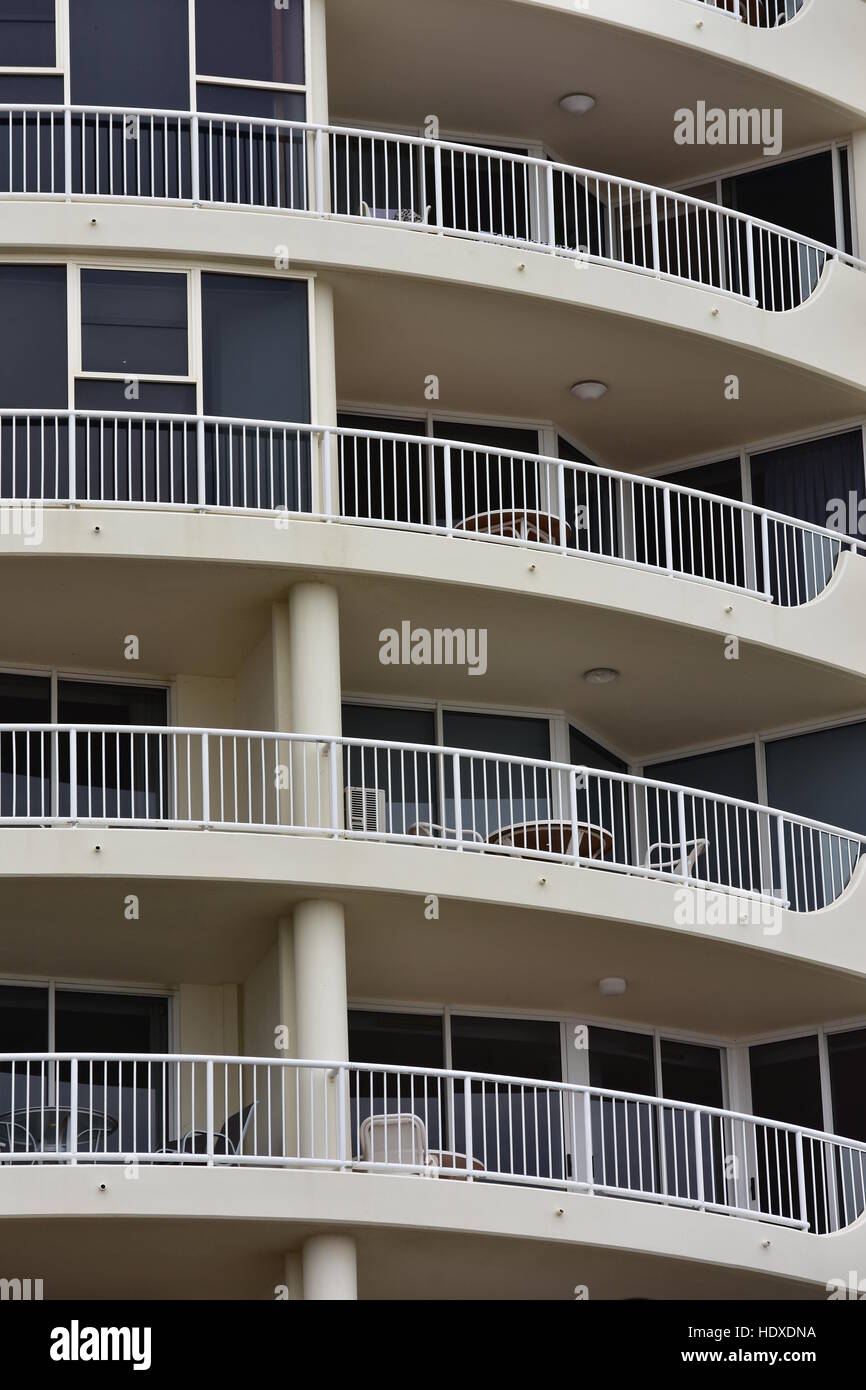 Detail view of curved balconies with metal tube railing on apartment ...