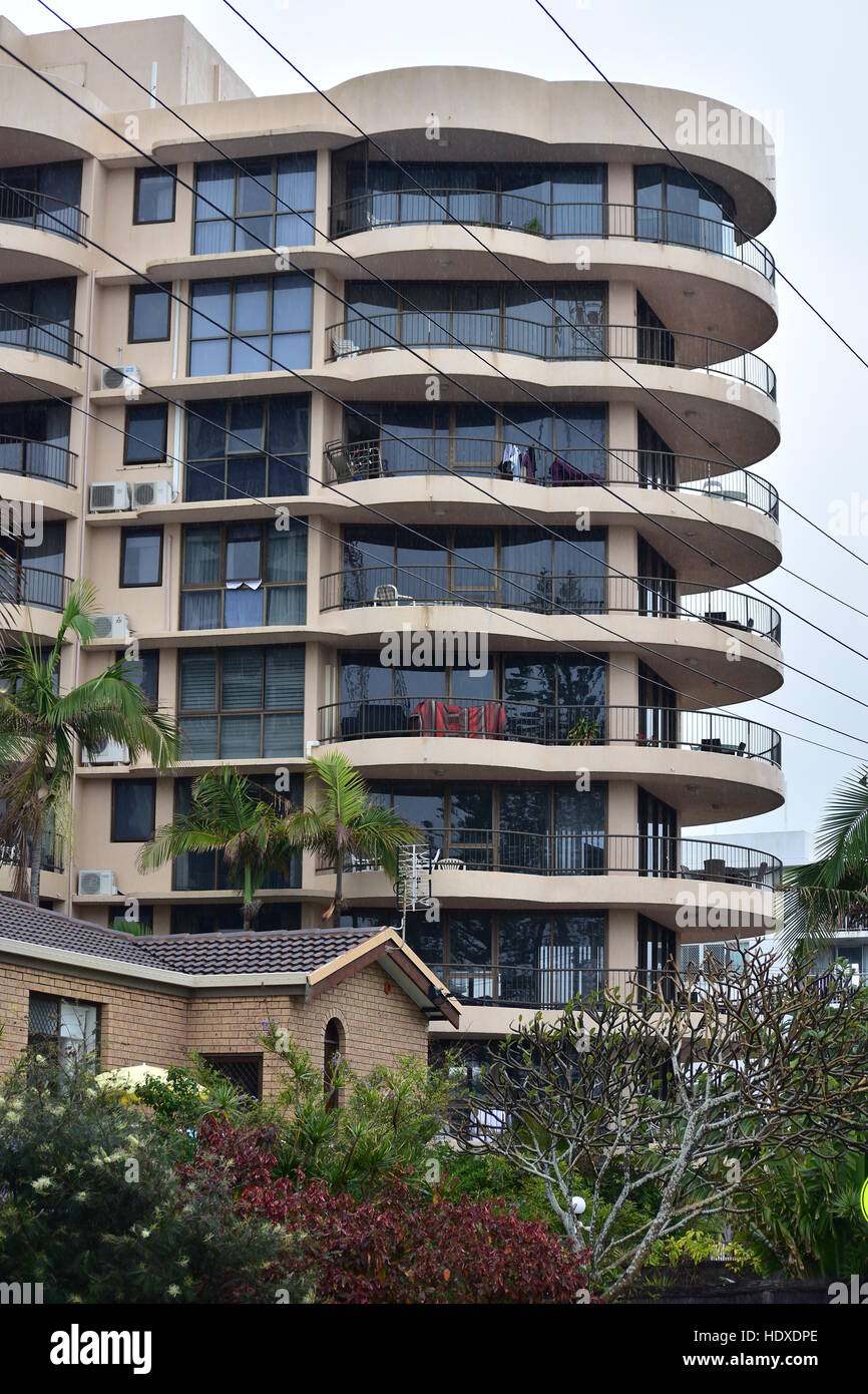 Multi-story apartment building with curved balconies along exterior ...