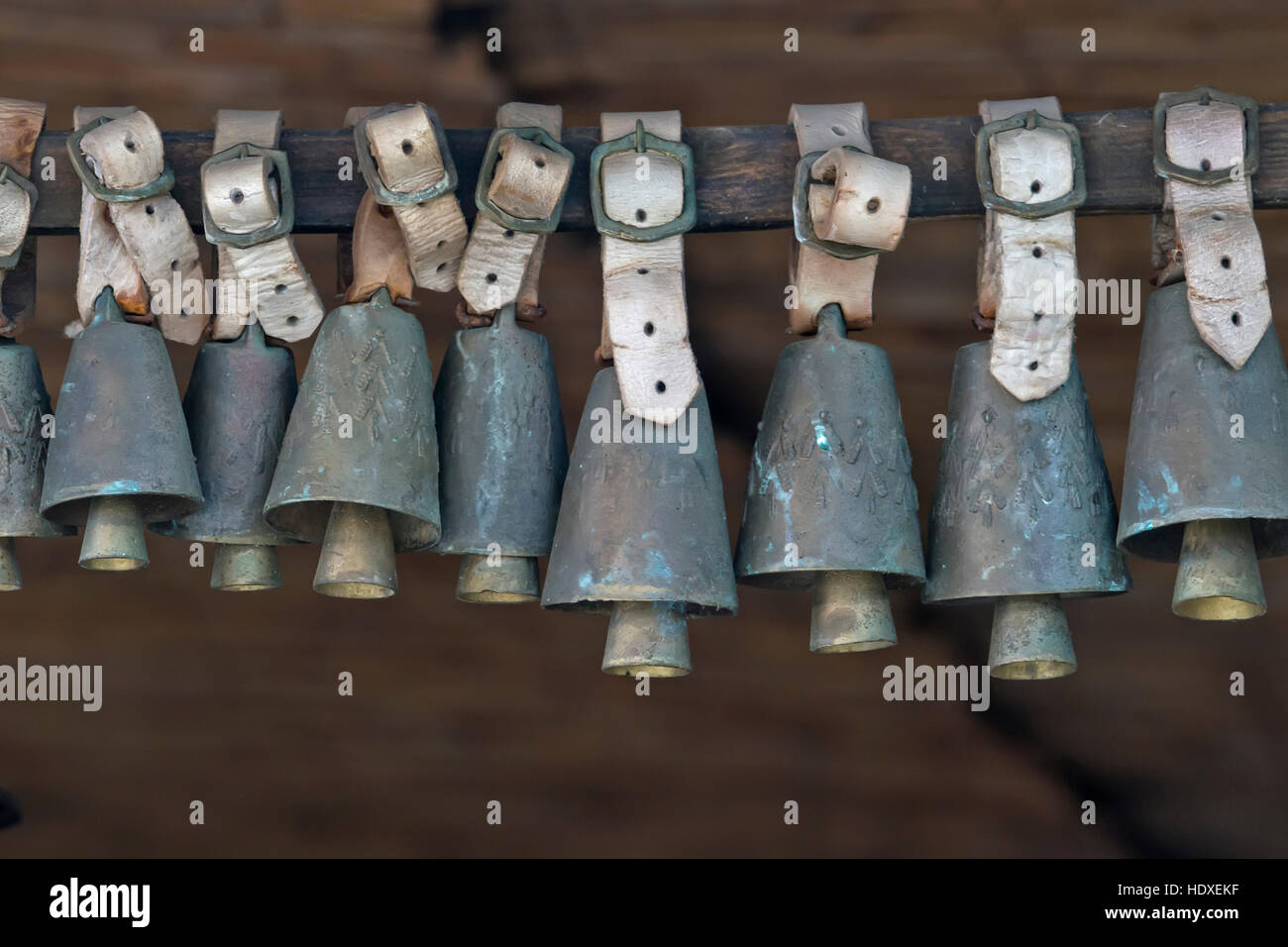 Animal bell hanging on a pole as a decoration Stock Photo - Alamy