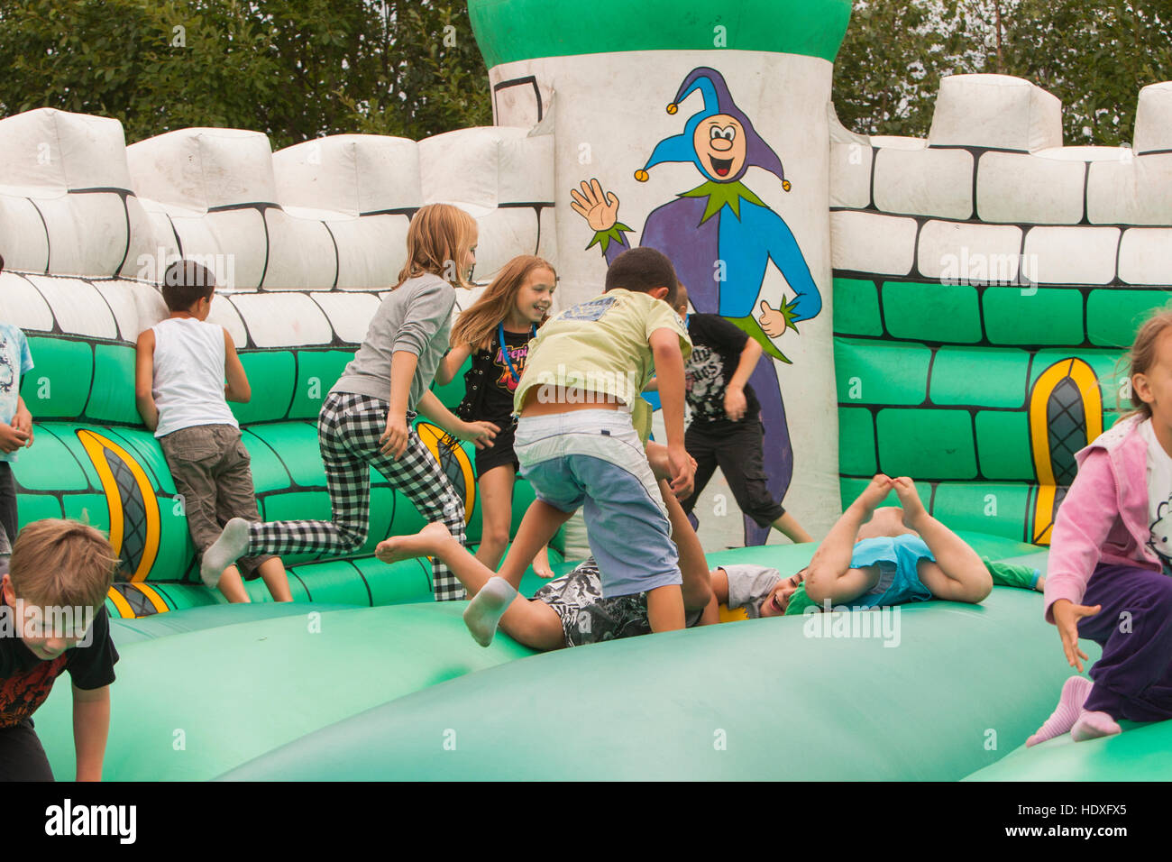 Children have fun in the bouncy castle Stock Photo - Alamy