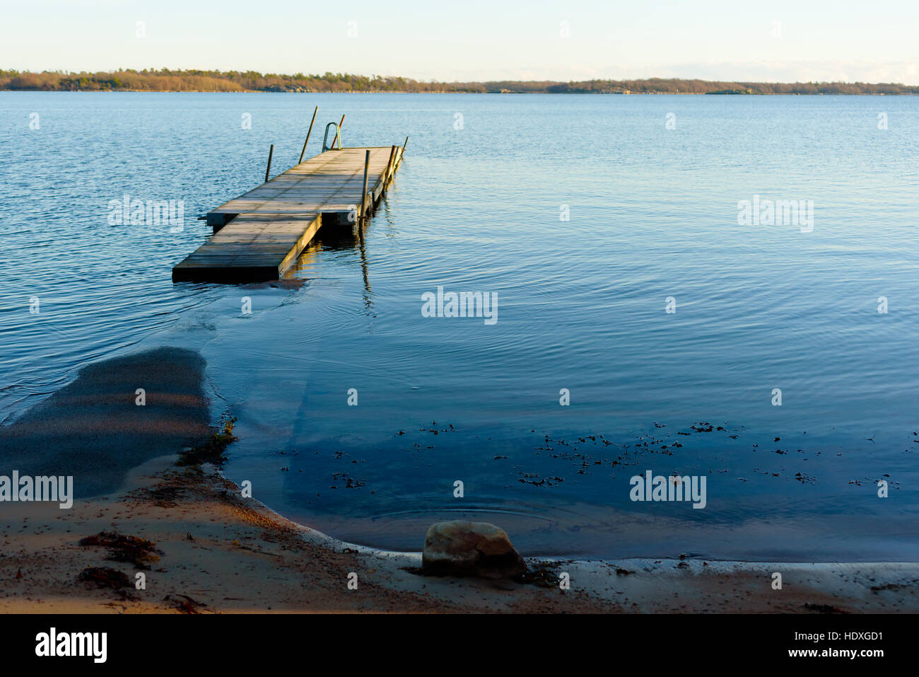 Empty floating swimming pier in calm and windless sea. Water level is ...