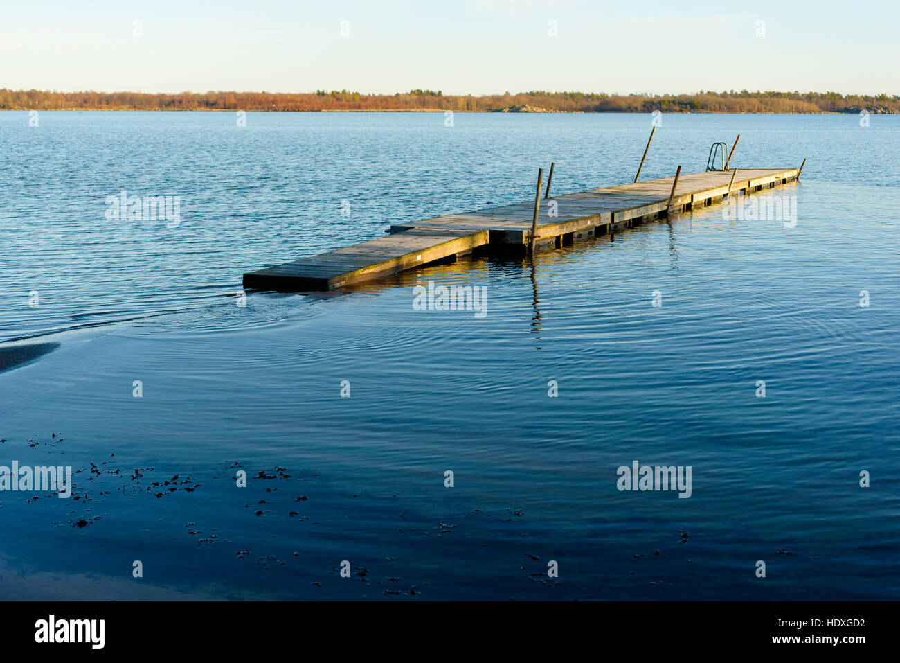 Empty floating swimming pier in calm and windless sea. Water level is ...