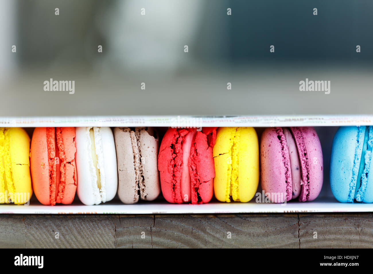Regular and cracked macaroons in a row in the box Stock Photo - Alamy