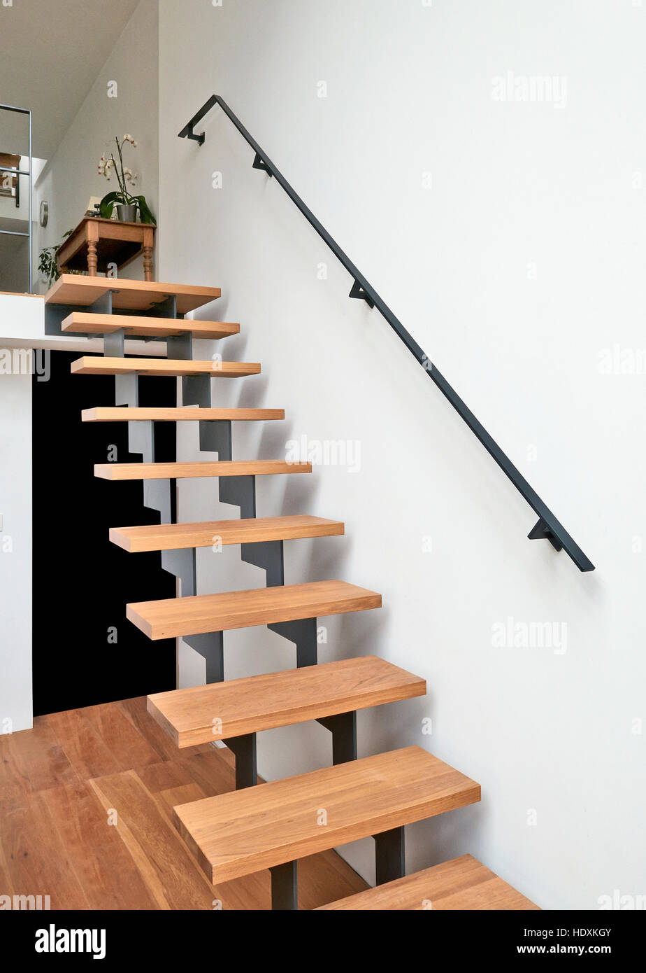 Hardwood stairs and ramp in modern renovated living room Stock Photo ...
