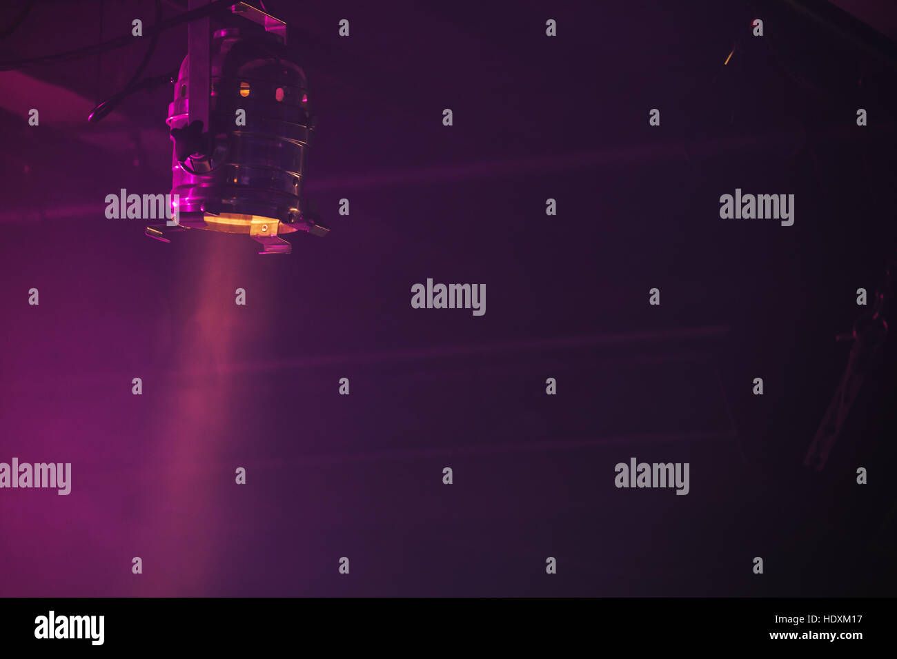 Scenic spot light beam over dark purple background, stage illumination ...