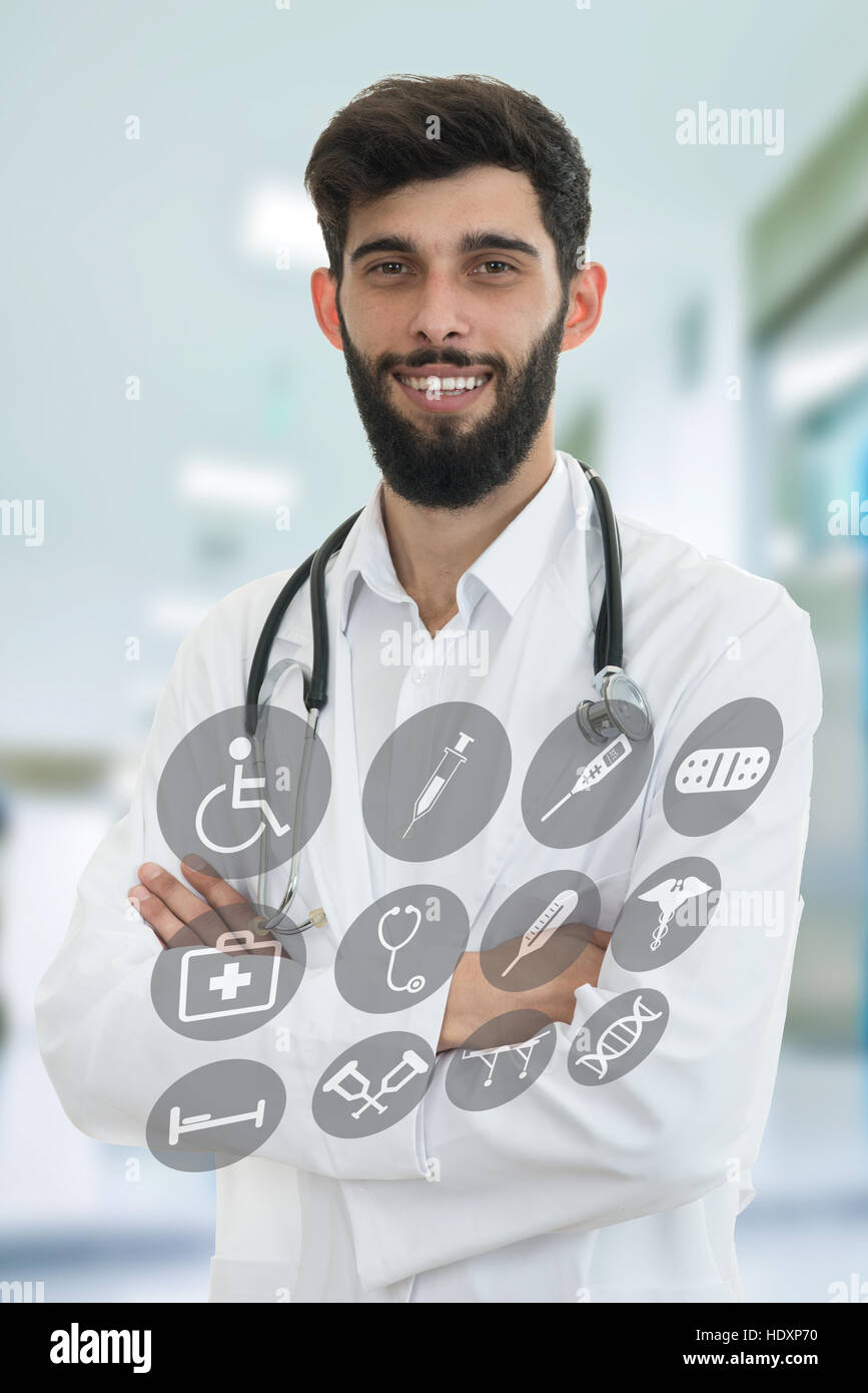 Young serious handsome bearded doctor with white coat and stethoscope ...