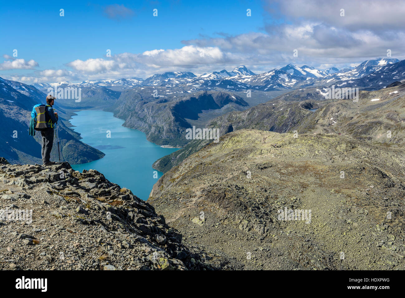 Hiker on the Besseggen ridge overlooking Gjende lake, Jotunheimen ...