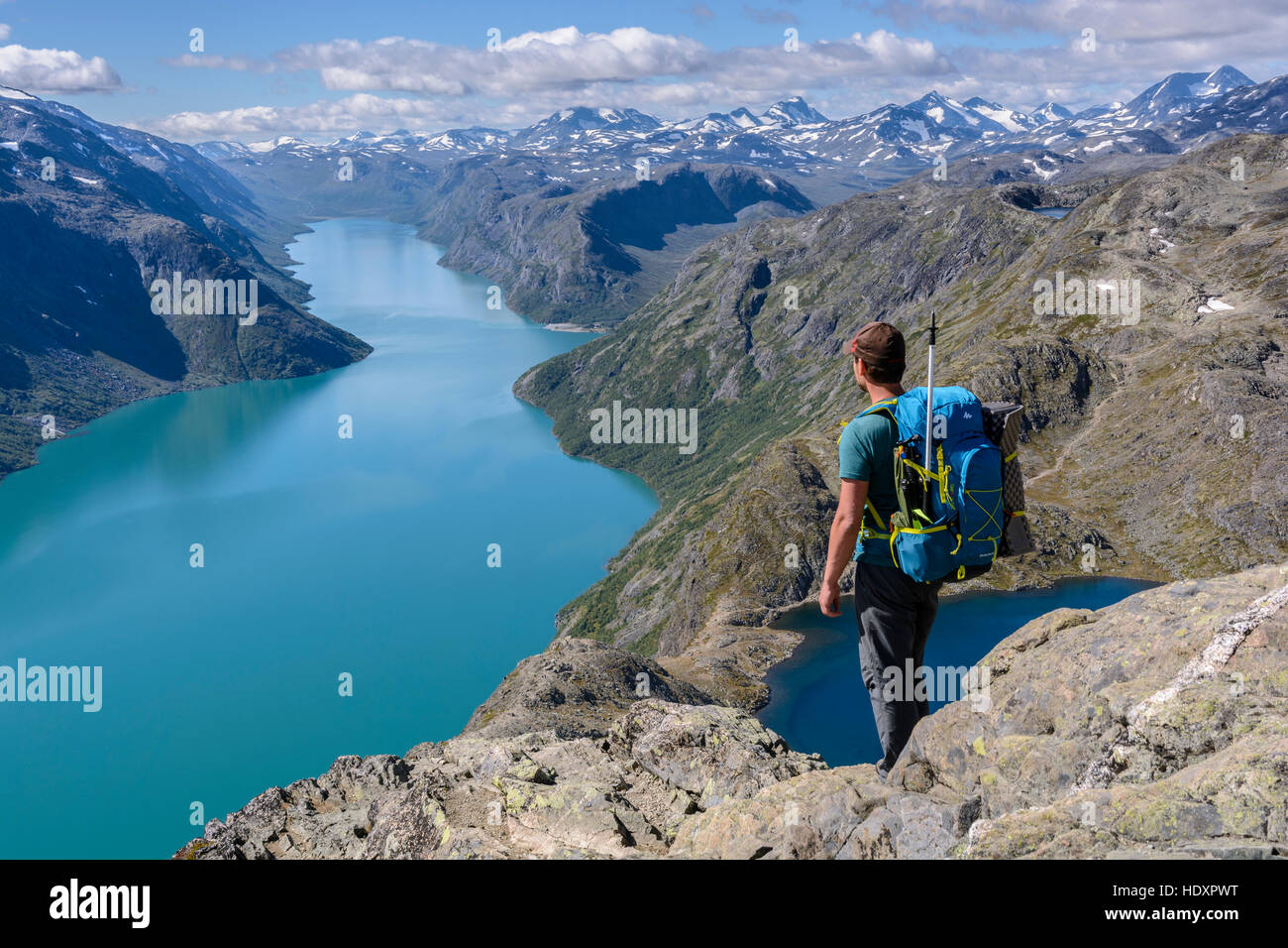 Hiker on the Besseggen ridge overlooking Gjende lake, Jotunheimen ...